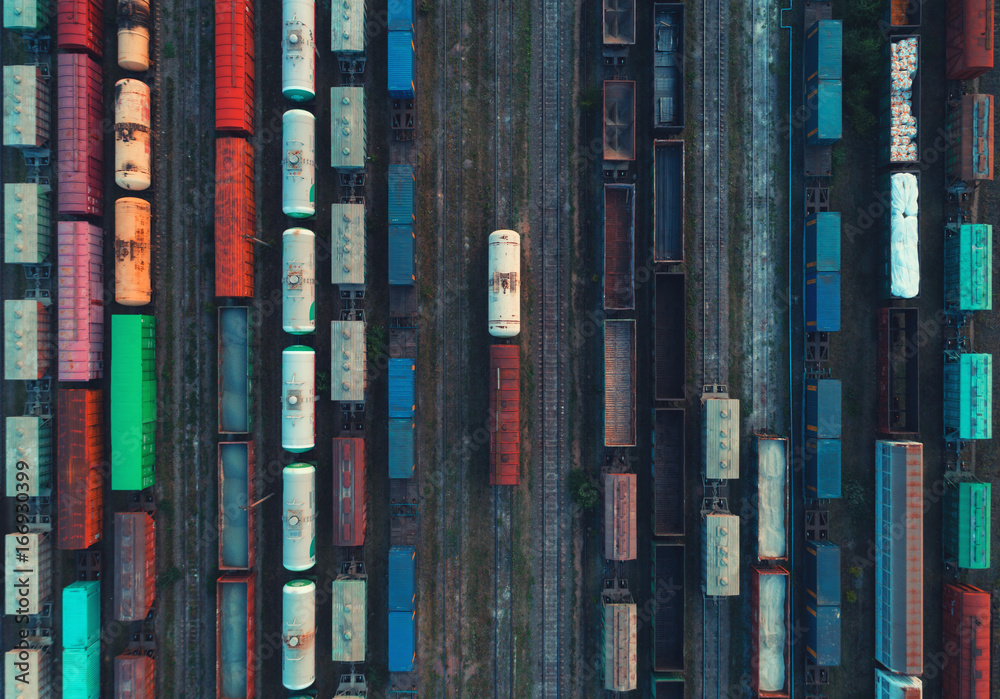 Aerial view of colorful freight trains on the railway station. Cargo ...