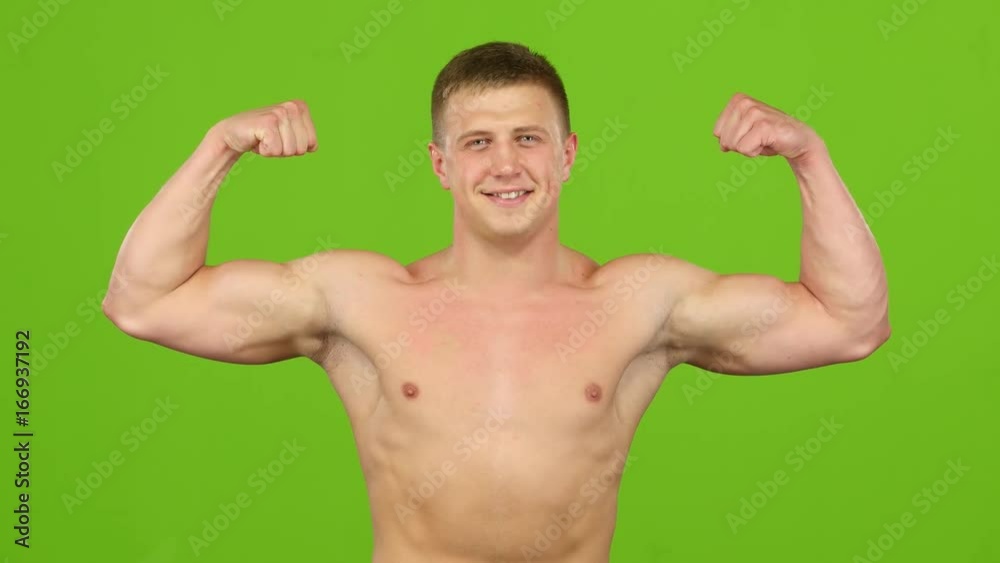 Man athlete shirtless showing their biceps and smiling. Green screen ...