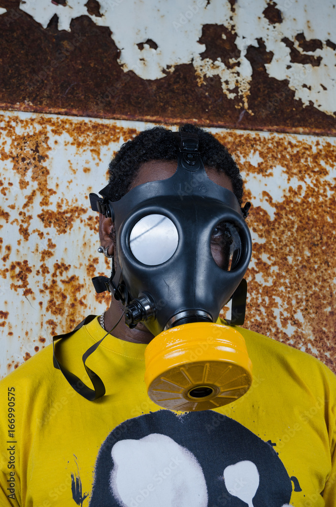 A scary man with reflection eyes in an industrial setting wearing a ...