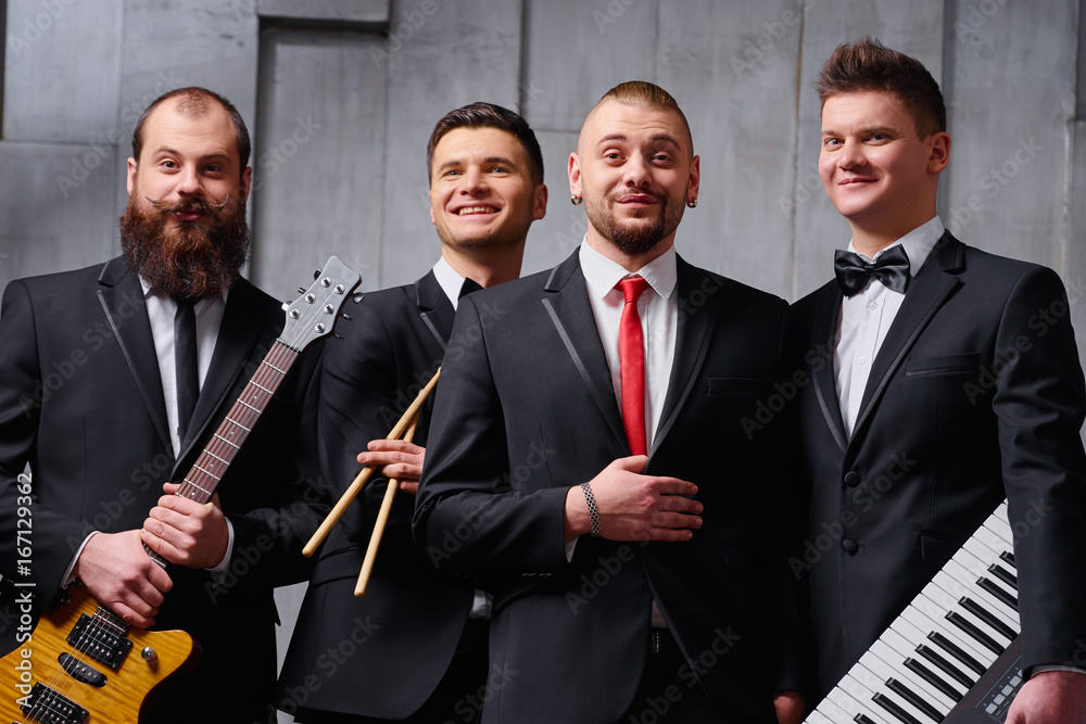 Music and fashion. Group portrait of musicians. Handsome young men in ...