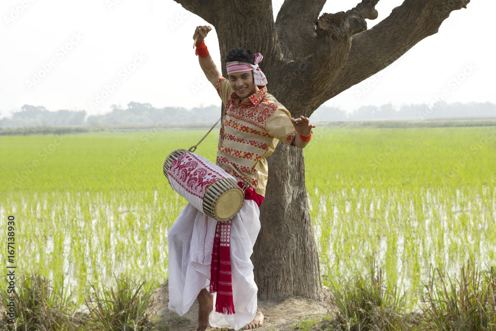 Portrait of Bihu man playing on a dhol Stock Photo | Adobe Stock