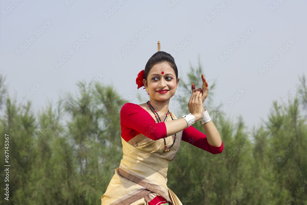 Woman performing Bihu dance Stock Photo | Adobe Stock