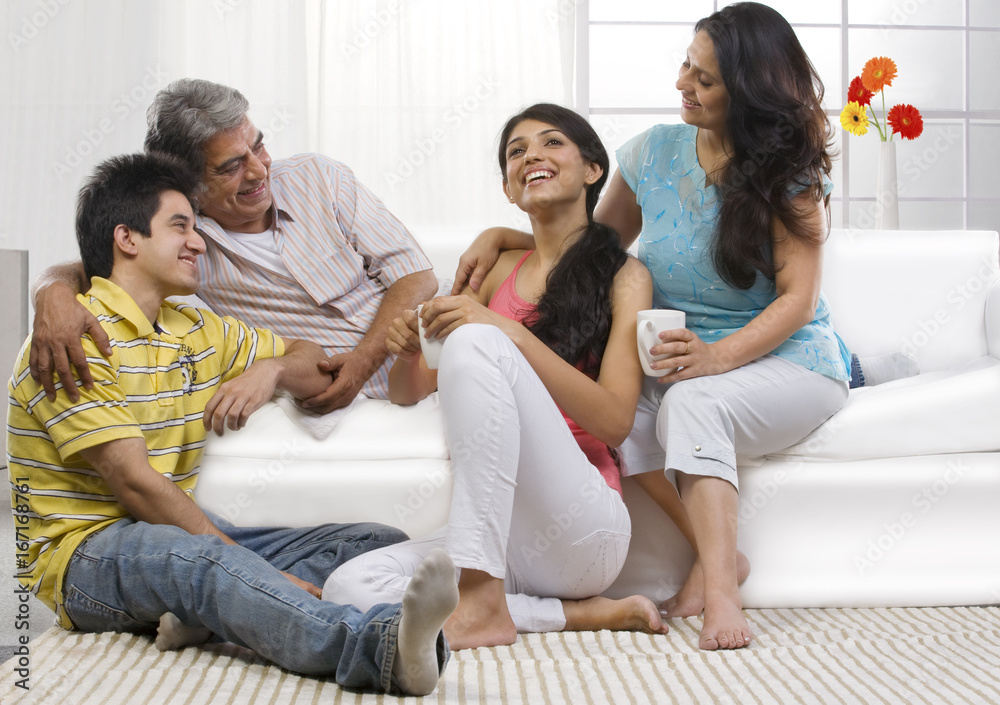 Family sitting together in the living room Stock Photo | Adobe Stock