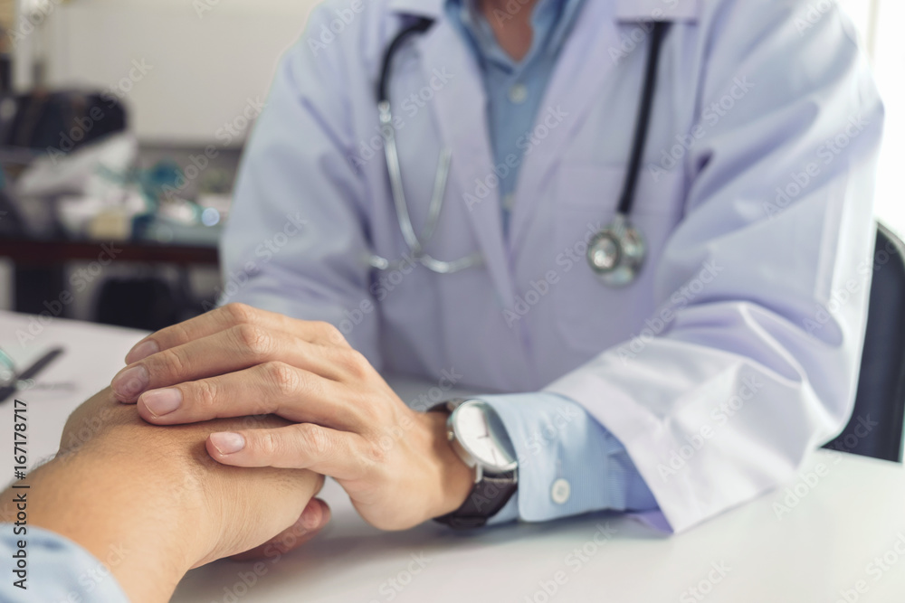 Close up of doctor touching patient hand for encouragement and empathy ...