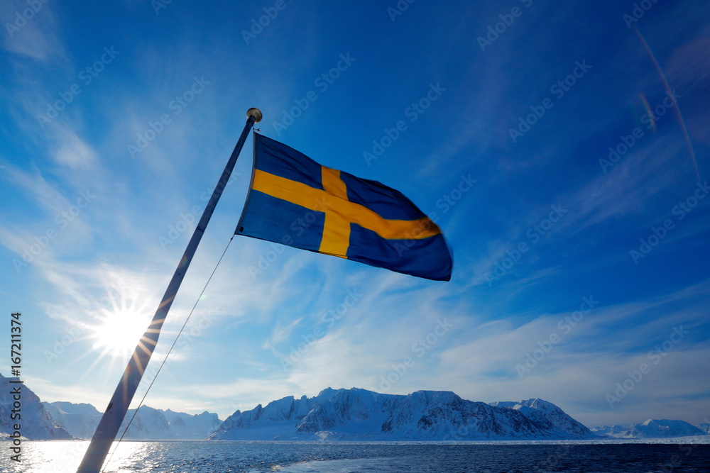 Sweden flag with blue sky. Rocky island with snow. White snowy mountain ...