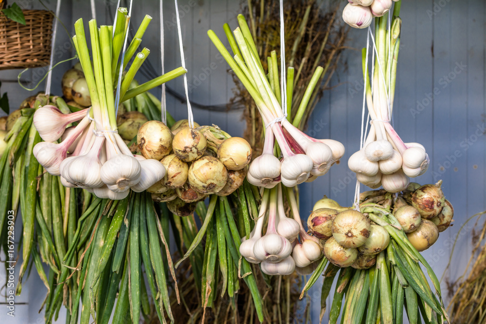 Hanging garlic braid and onion bundles, drying spices and bio ...