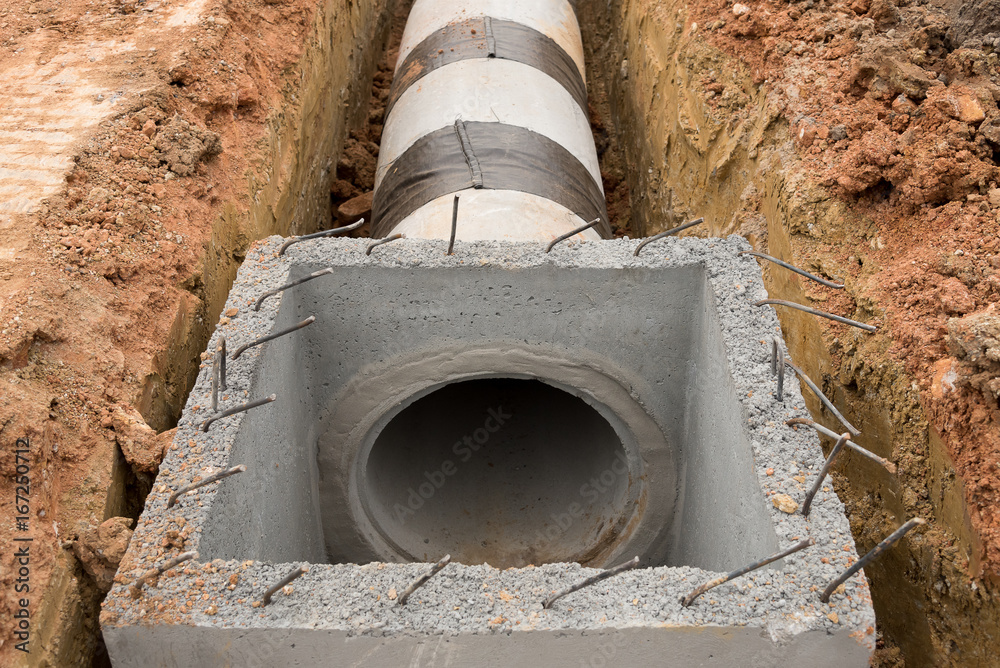 Concrete drainage pipe and manhole. Stock Photo | Adobe Stock