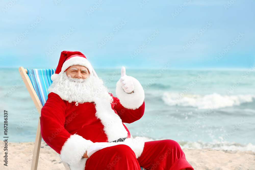 Authentic Santa Claus relaxing in deck chair on beach Stock Photo ...