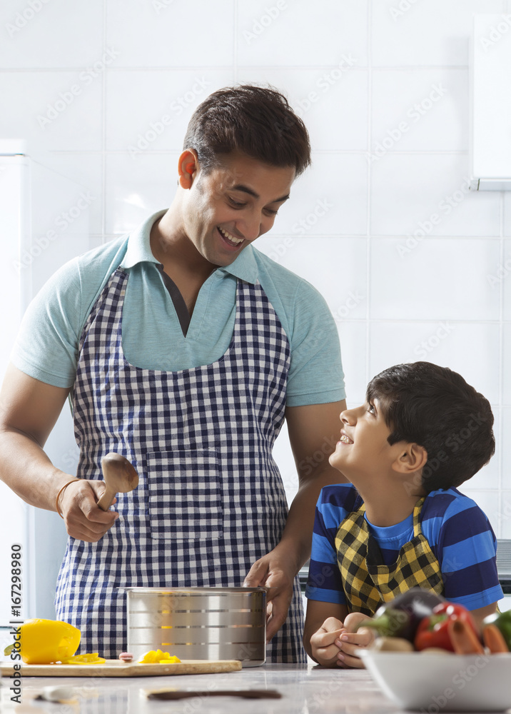 Father and son cooking in kitchen Stock Photo | Adobe Stock