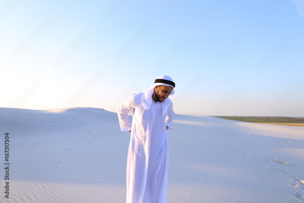 Handsome Arab sheik suffers from discomfort in back, standing in Stock ...
