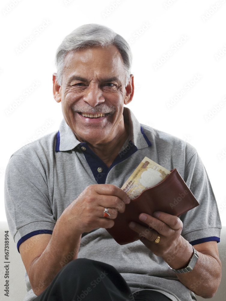 Old man taking money out of a wallet Stock Photo | Adobe Stock