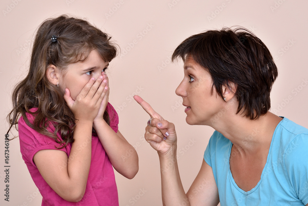 Angry mother scolding a scared daughter Stock Photo | Adobe Stock