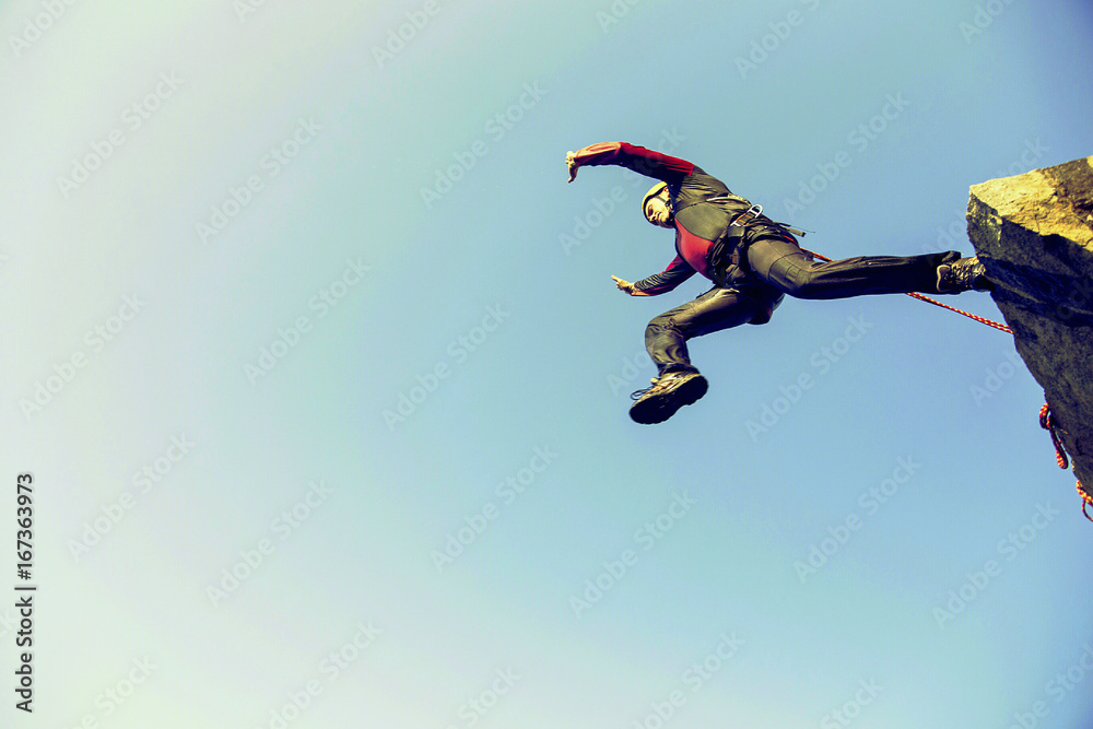 Jump off a cliff into a canyon with a rope. Stock Photo | Adobe Stock