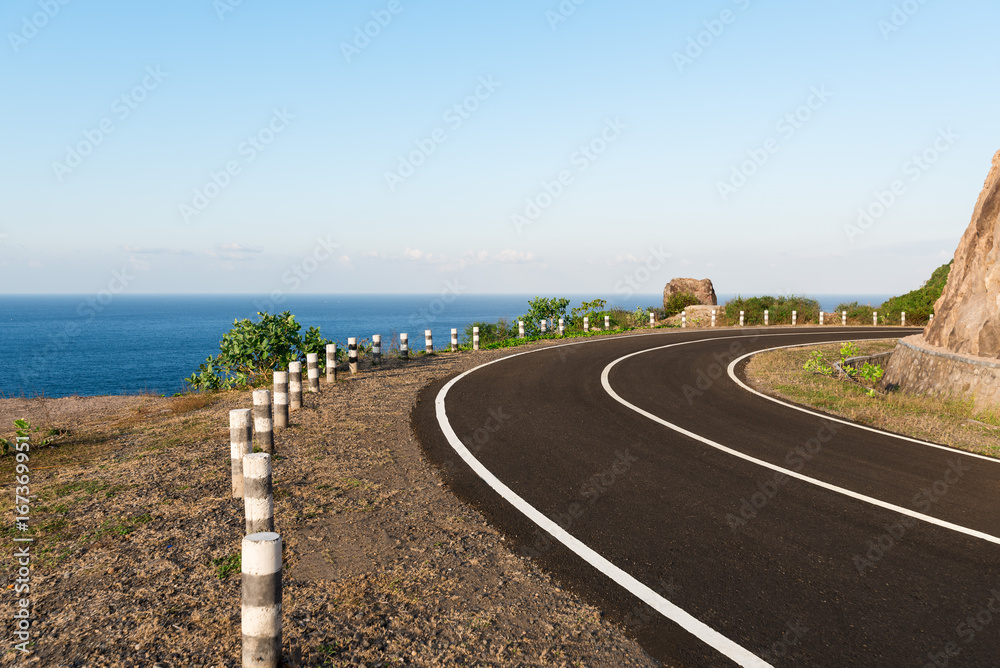 Asphalt coastal road going round cliff edge bend. Stock Photo | Adobe Stock
