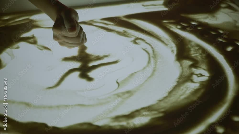 Drawing with sand. Short show. Drawing sand on a white screen. Sand ...