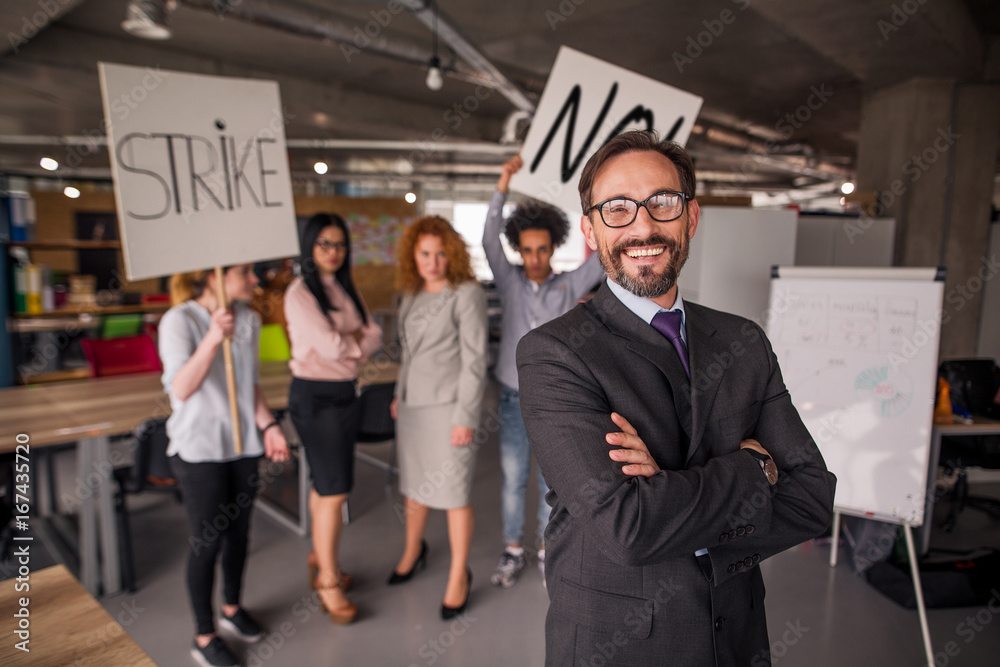 Modern office concept, director standing with his back to striking ...