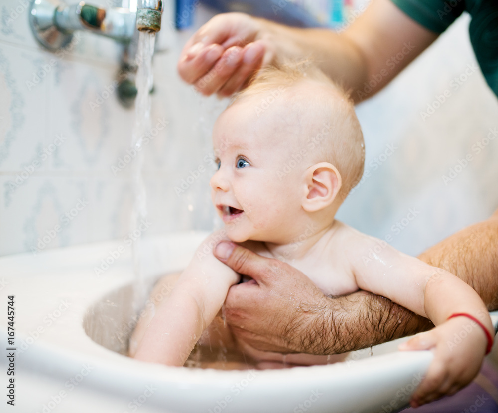 Happy laughing baby taking a bath. Little child in a bathtub. Smiling ...