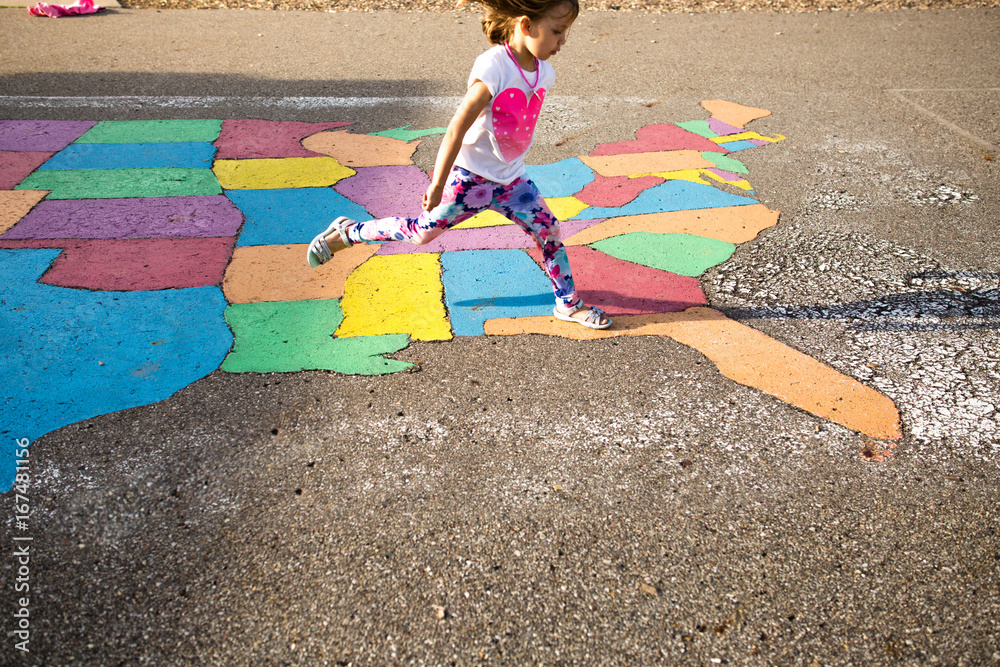 Girl stepping on painted ground map, USA Stock Photo | Adobe Stock