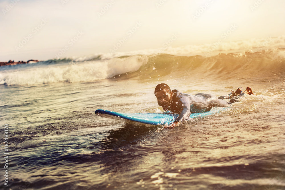 Handsome man has surfing on small waves. Mixed race dark skin and beard ...