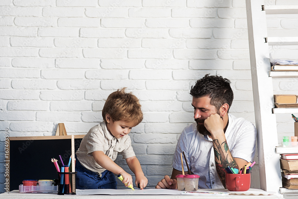 Crayons drawing family, father looks how son draws. Development of ...