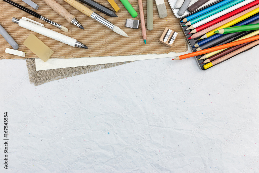 artist drawing tools: various colored pencils, chalks, paintbrushes on ...