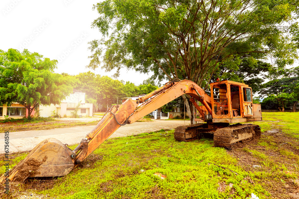Old Excavator or backhoe at the construction site, sunset background ...