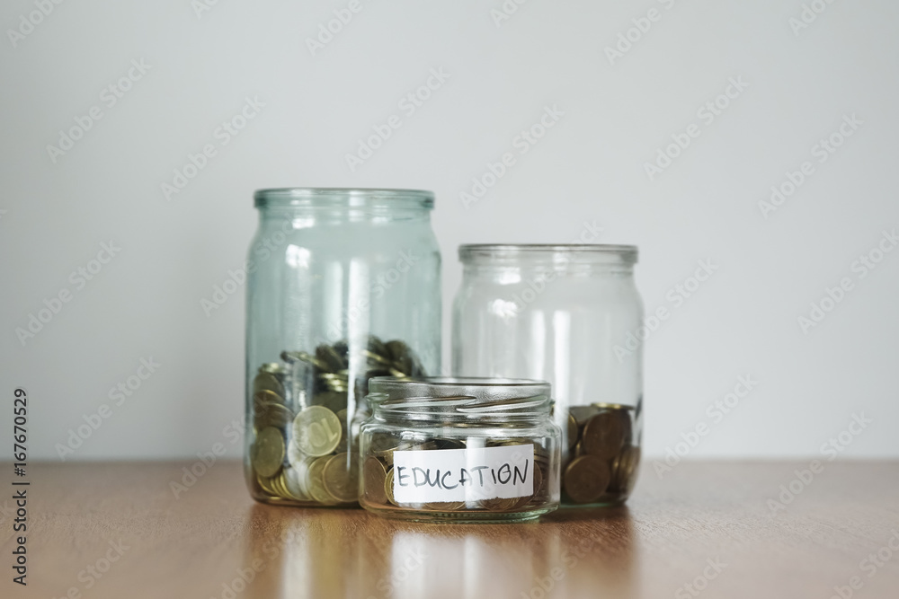Coins in glass jars for different needs Stock Photo | Adobe Stock