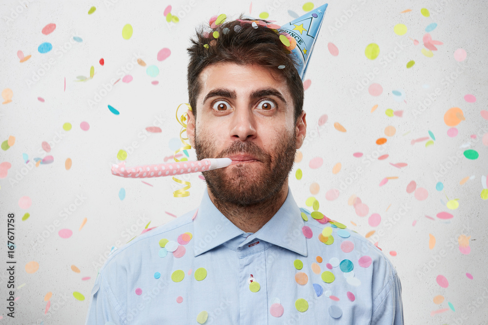 Portrait of bearded man who is celebrating his birthday party, wearing ...