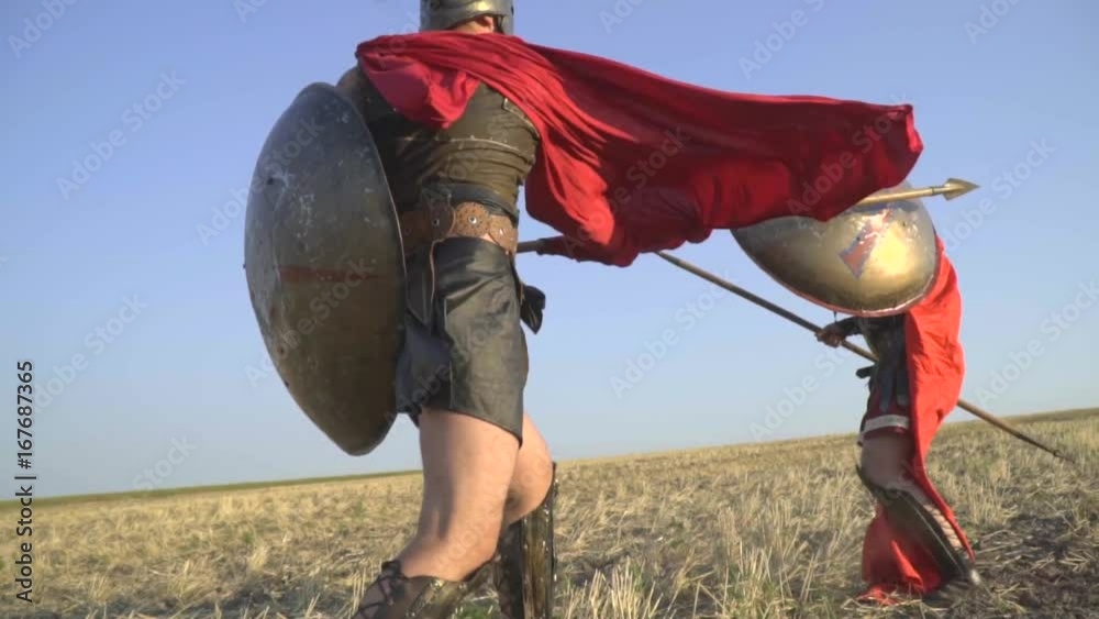 The Greek Legionnaire beats the enemy with a spear and pushes his foot ...