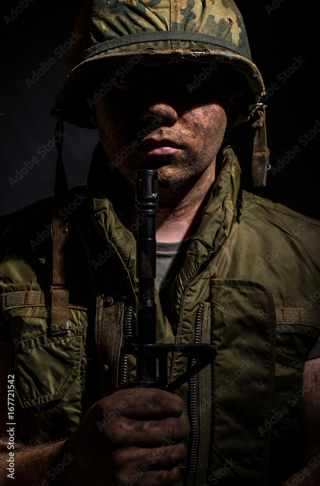 US Marine (Vietnam War) looking at camera with face in shadow and ...