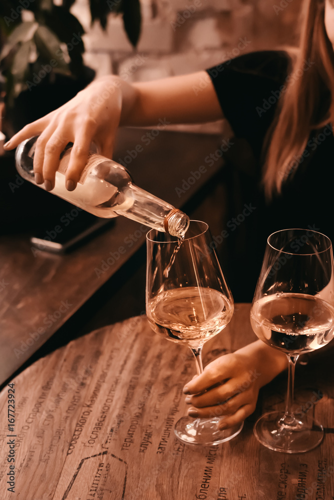 Hand Pouring Glass Of Wine