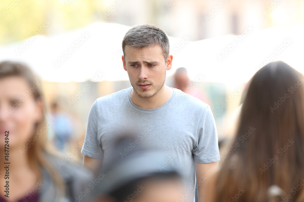 Sad boy walking on the street Stock Photo | Adobe Stock