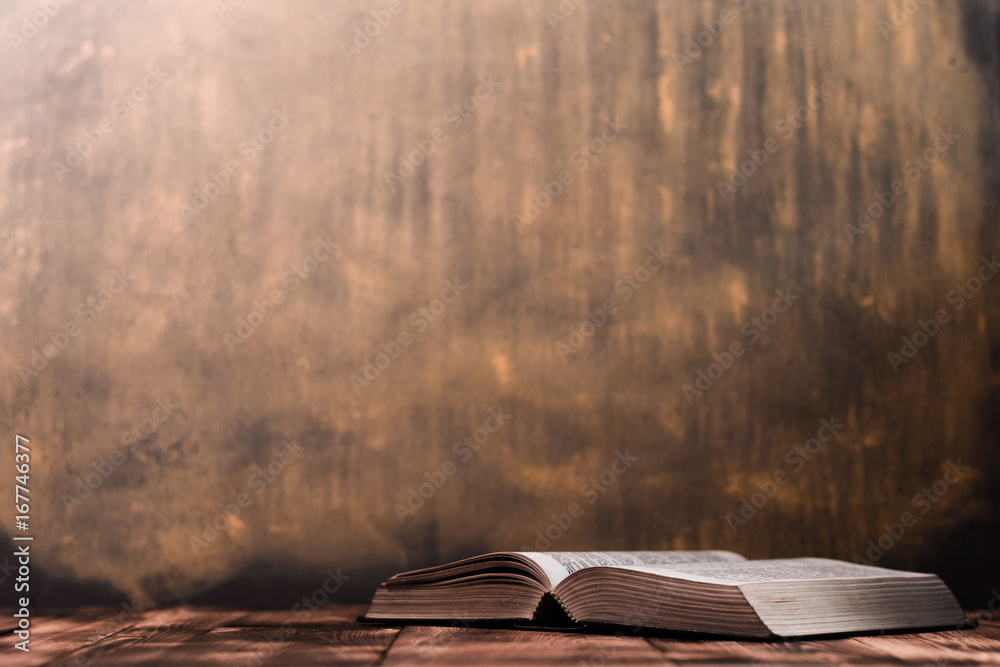Bible and the crucifix on a wooden dark table. Beautiful gold ...