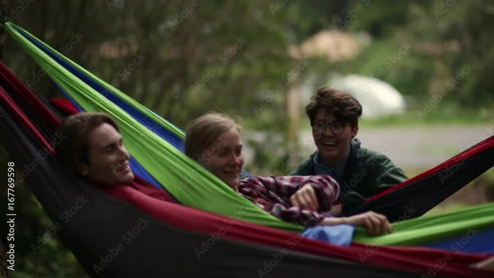 Group Of Friends Enjoy Hanging Out In Hammocks At Campground, Man Hides ...