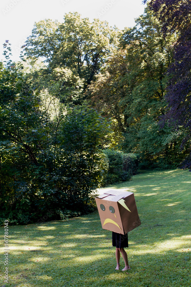 Girl with sad face box over head Stock Photo | Adobe Stock
