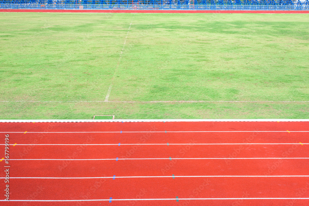 Red running track in stadium with field grass Stock Photo | Adobe Stock