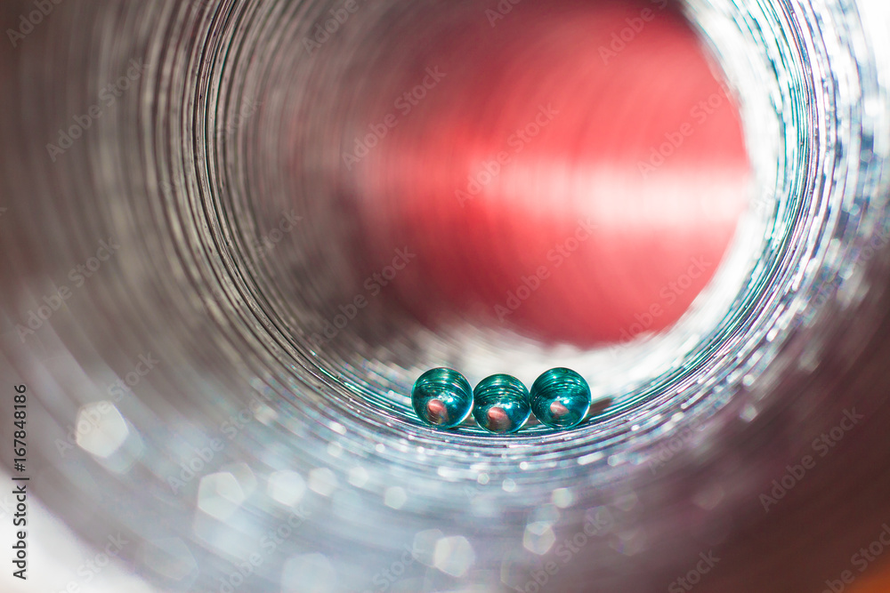 Foto de Three transparent small ball on the surface inside the pipe ...