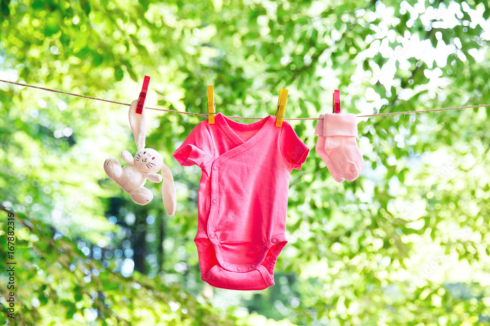 Baby clothes hanging on the clothesline. Stock-Foto | Adobe Stock
