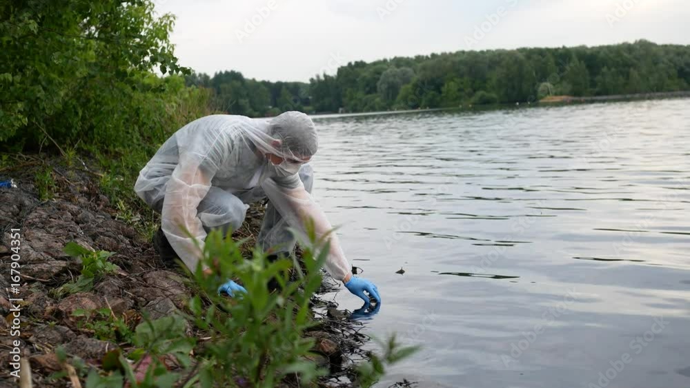 Vidéo Stock Bbiologist in biohazard suits and masks sampling water from ...