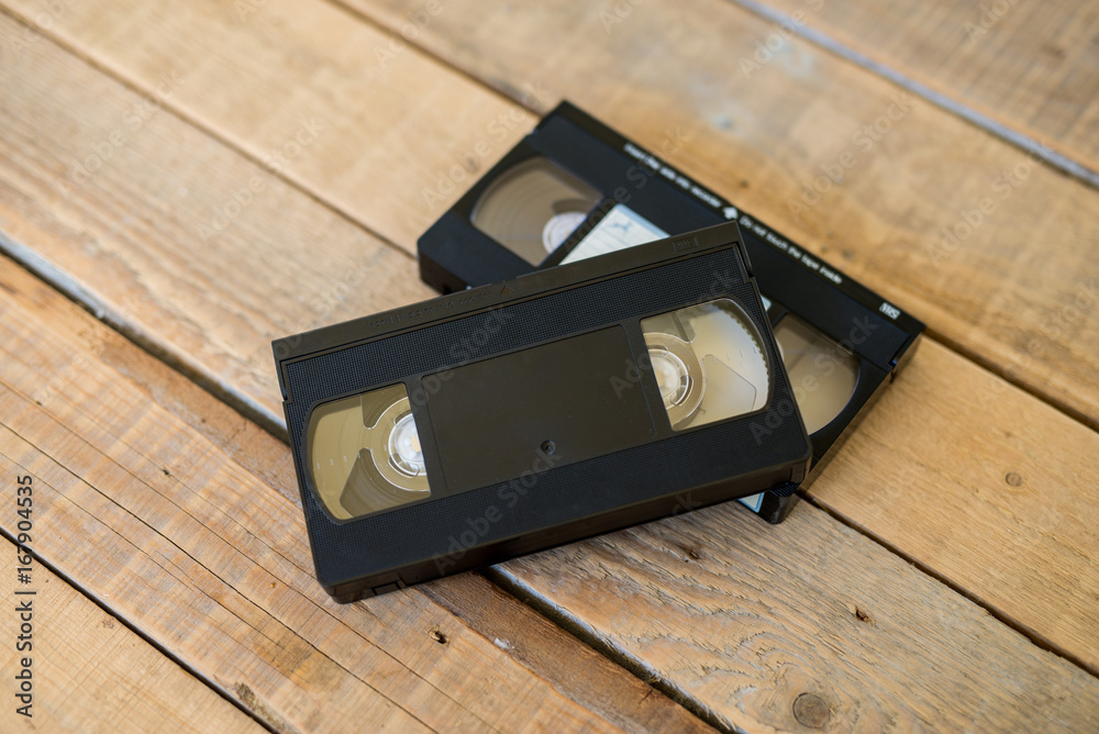 stack of VHS video tape cassette on white wooden table, retro filter ...