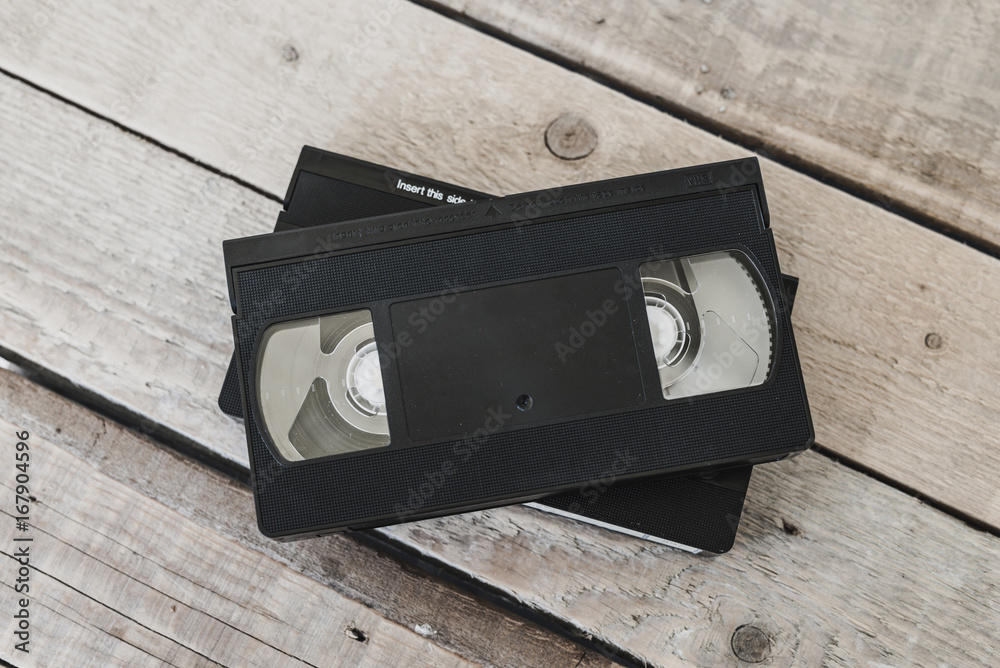 stack of VHS video tape cassette on white wooden table, retro filter ...