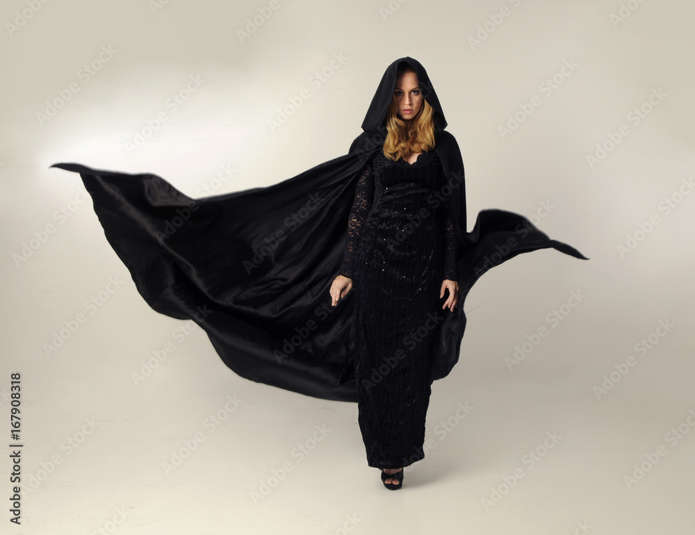 full length portrait of a blonde lady wearing black lace now and hooded ...