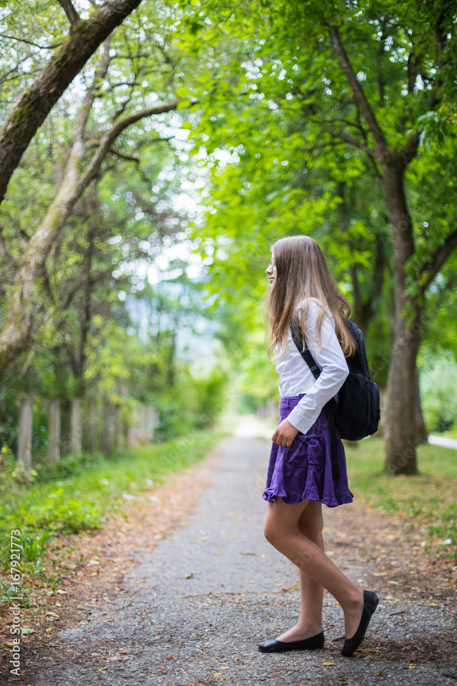 Pretty beautiful blonde child girl cheerful and happily walking across ...