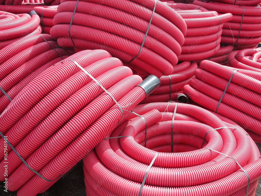 Red corrugated plastic pipes used for underground electrical lines ...