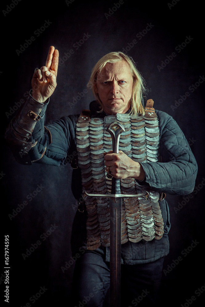 Portrait of praying Templar knight on a dark background. Stock Photo ...