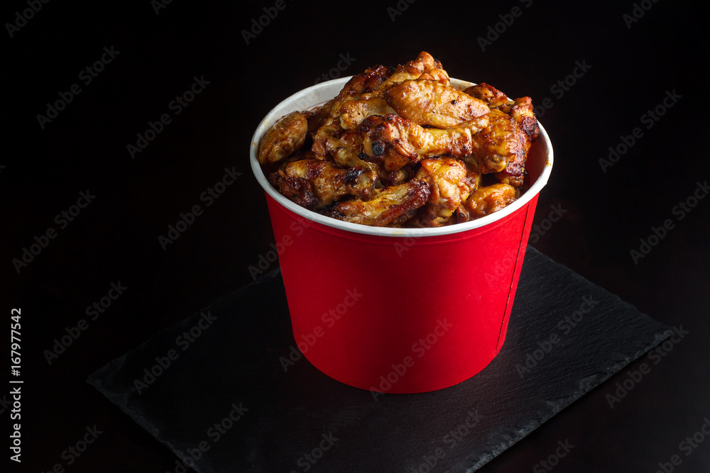 Chicken legs in a bucket. Stock Photo | Adobe Stock