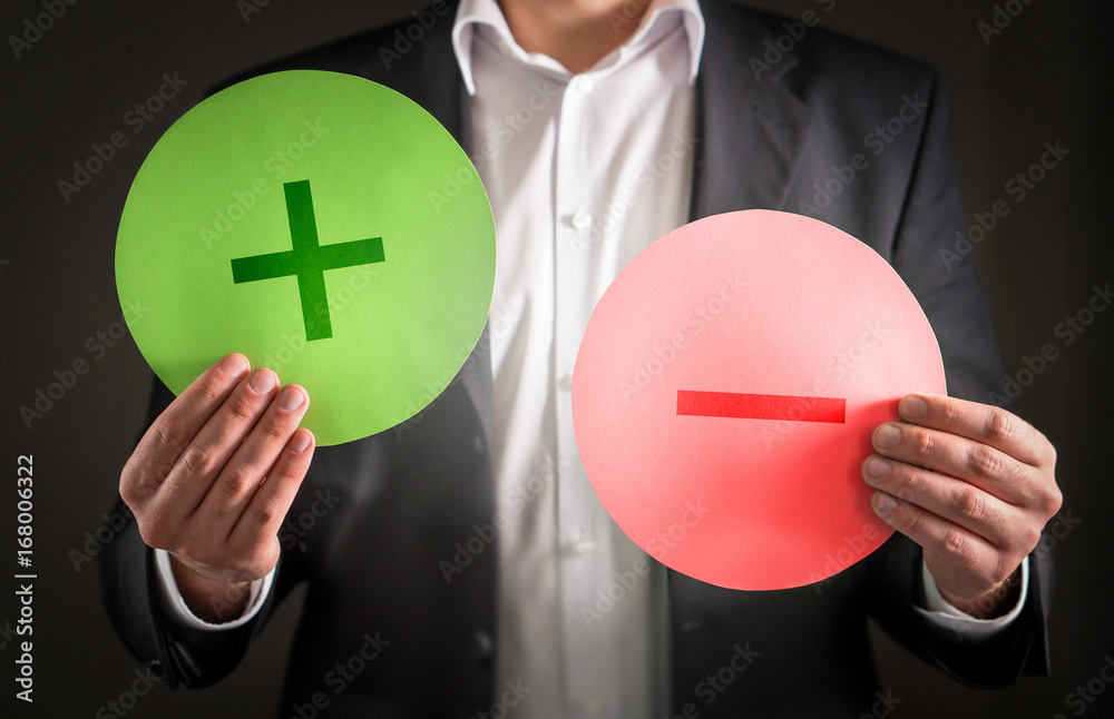 Pros and cons concept. Business man with cardboard plus and minus ...