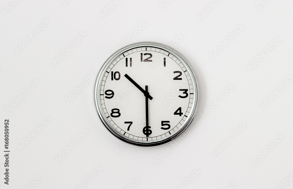 White Clock hanging on a white wall showing time 10:30 Stock Photo ...