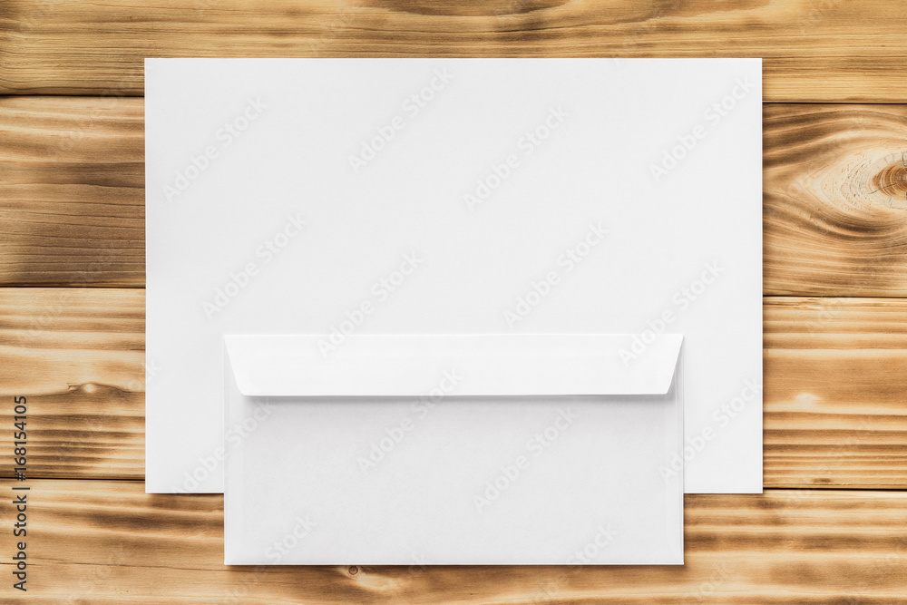 Mockup of blank A4 paper list and back side envelope at wooden board ...