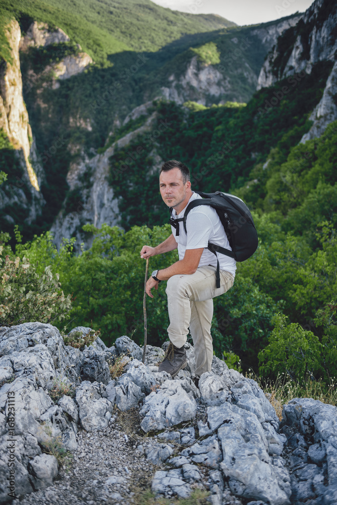 Hiker standing on the mountain top Stock Photo | Adobe Stock
